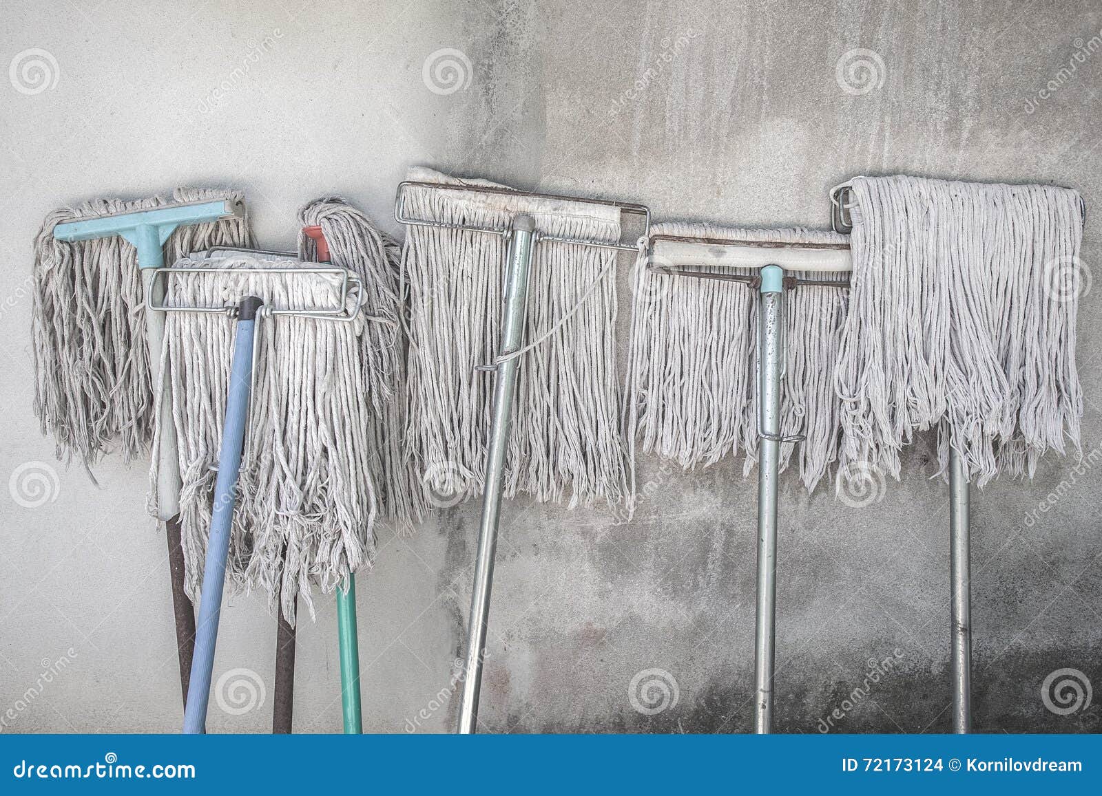 White Mops Lean Against White Wall Stock Photo - Image of products ...