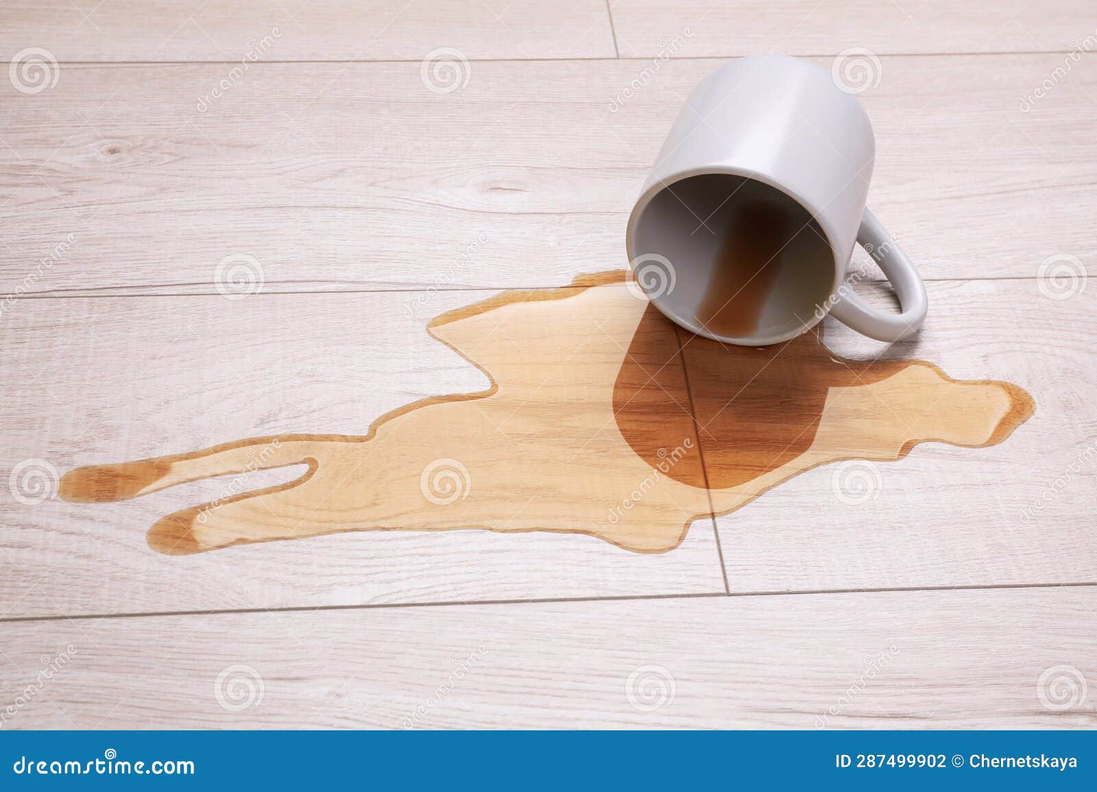 White Mug with Spilled Liquid on Wooden Floor Stock Photo - Image of ...