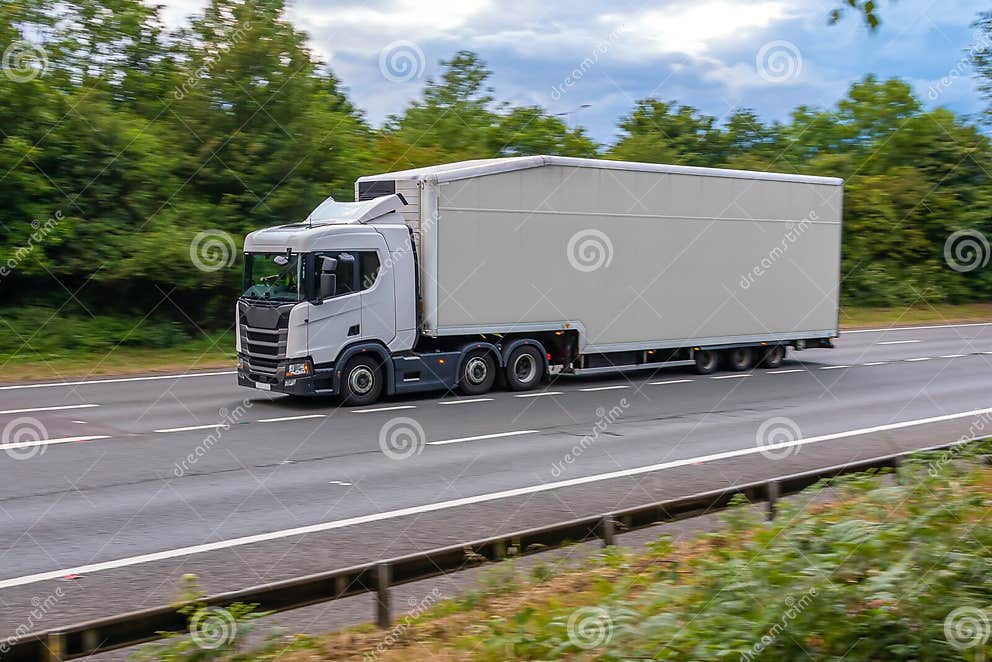 White No Name Double Decker Lorry in Motion on the Motorway. Stock ...