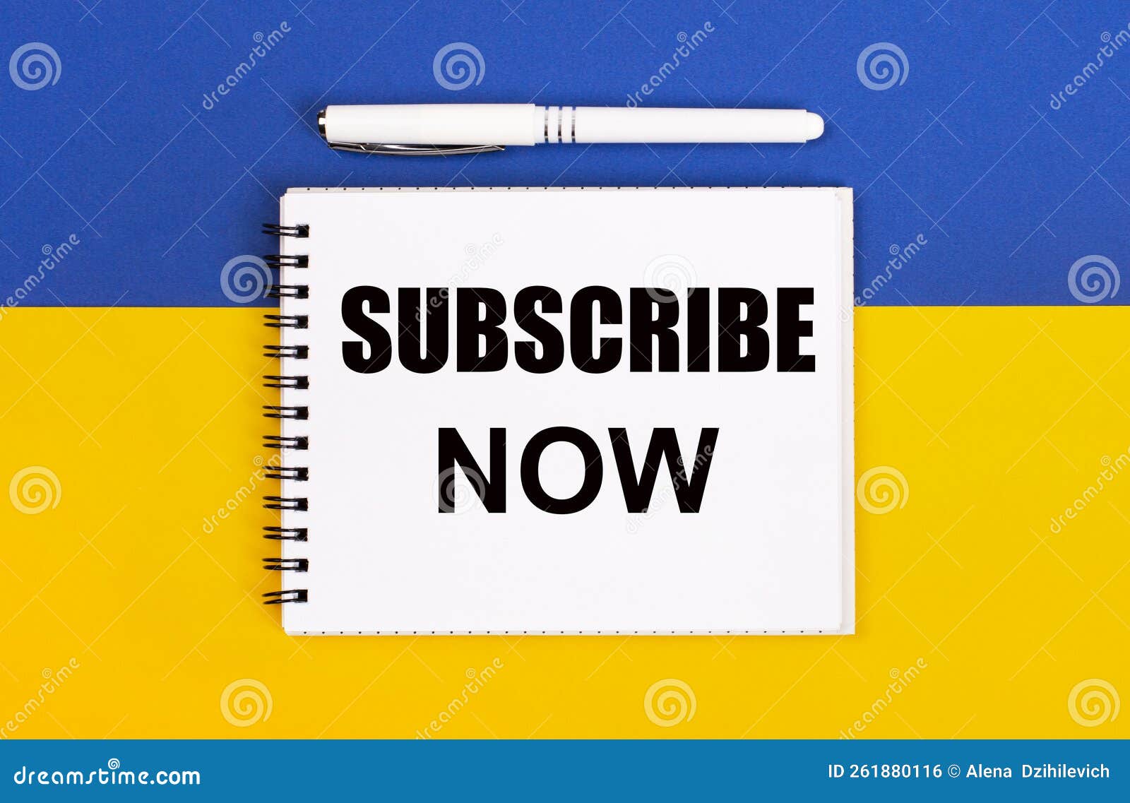 A White Notebook with the Text SUBSCRIBE NOW and a White Pen on a Blue ...