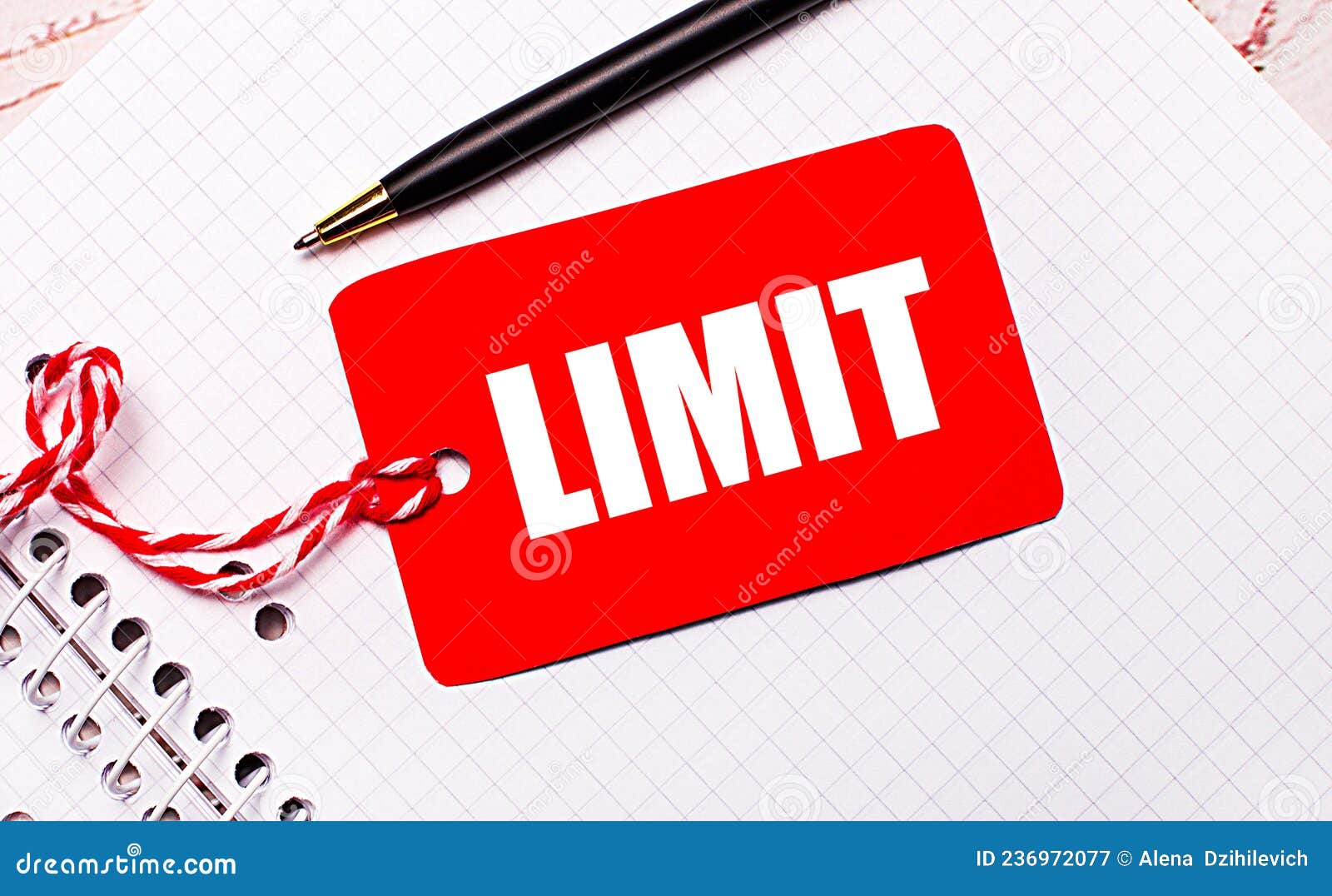On a White Notebook There is a Black Pen and a Red Price Tag on a ...