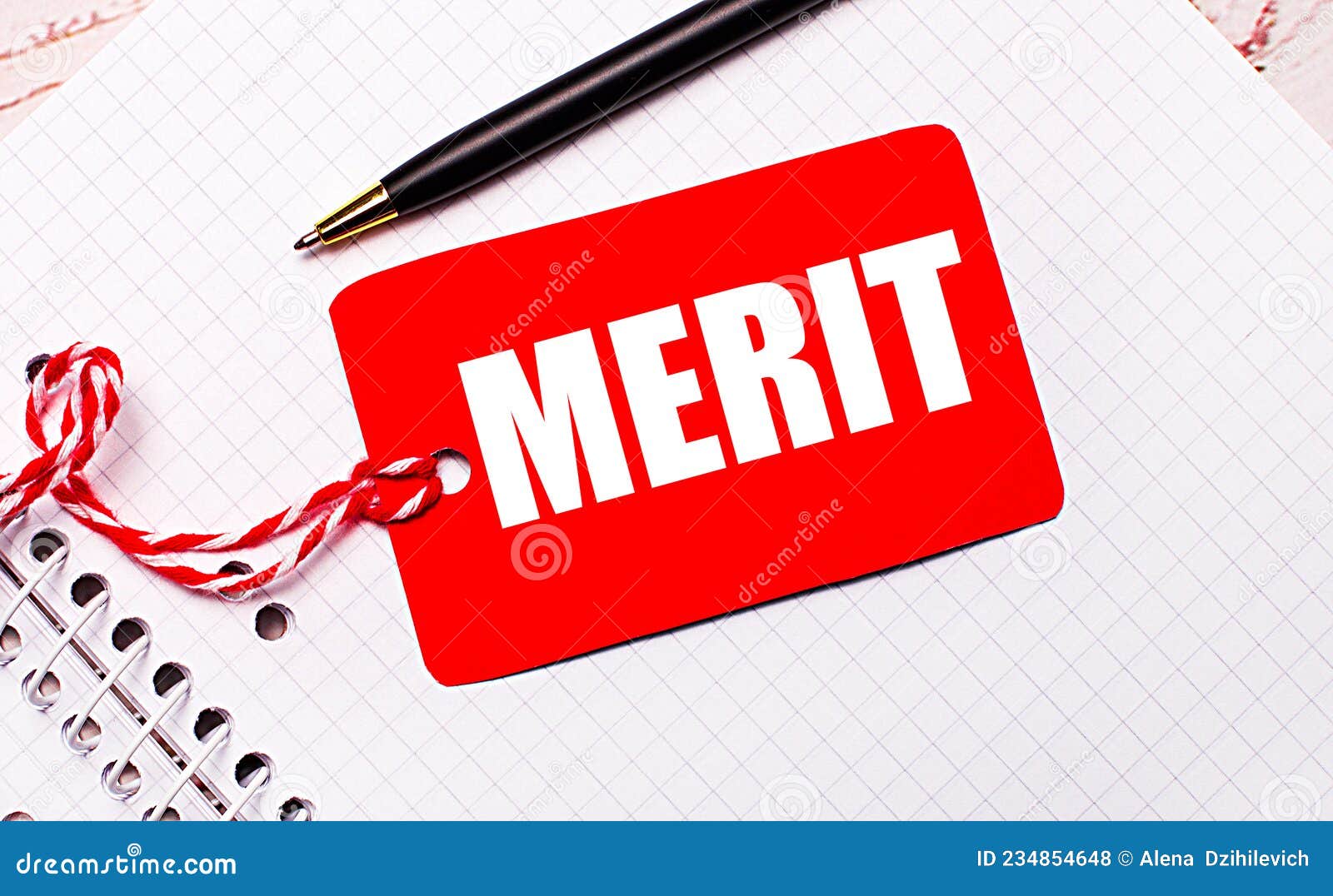 On a White Notebook There is a Black Pen and a Red Price Tag on a ...