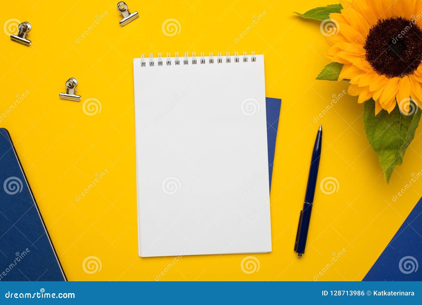 White Notepad with Blue Notebook and Pen on Yellow Background Stock ...