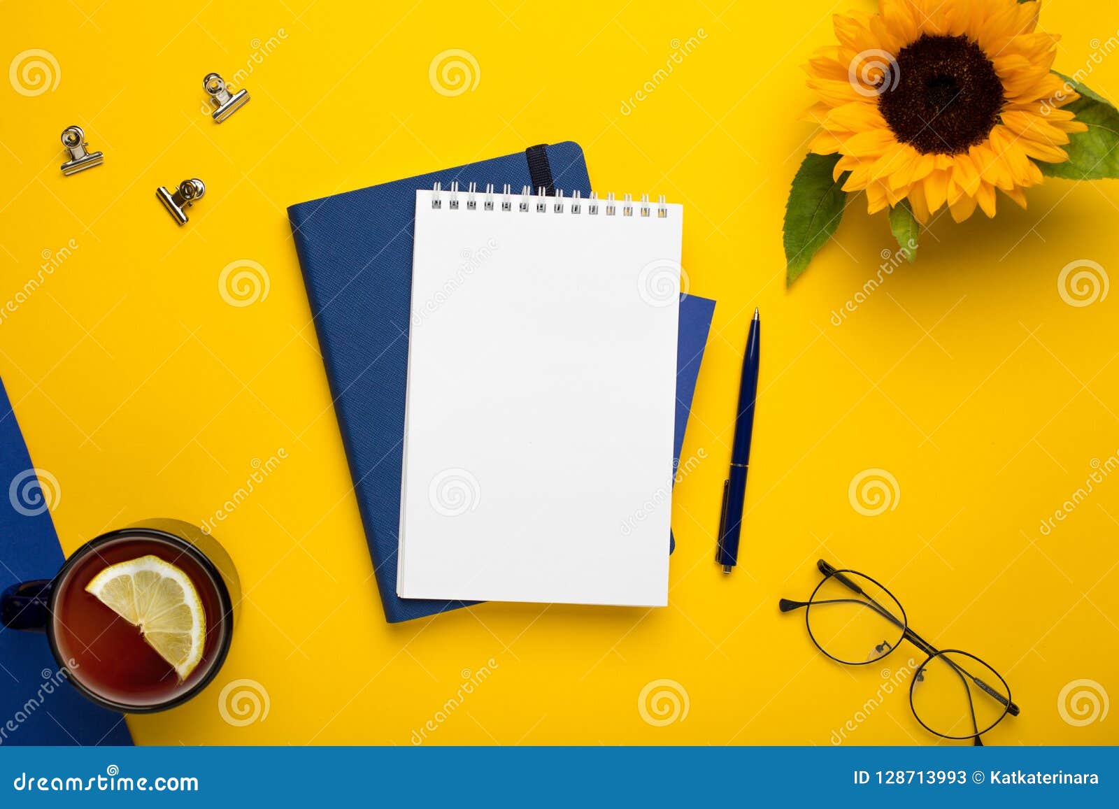 White Notepad with Blue Notebook and Pen on Yellow Background Stock ...