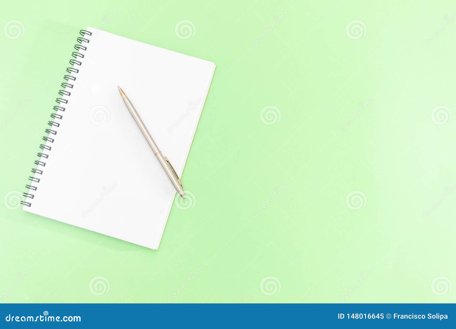 White Notepad with Steel Pen on a Green Background. Office Table ...