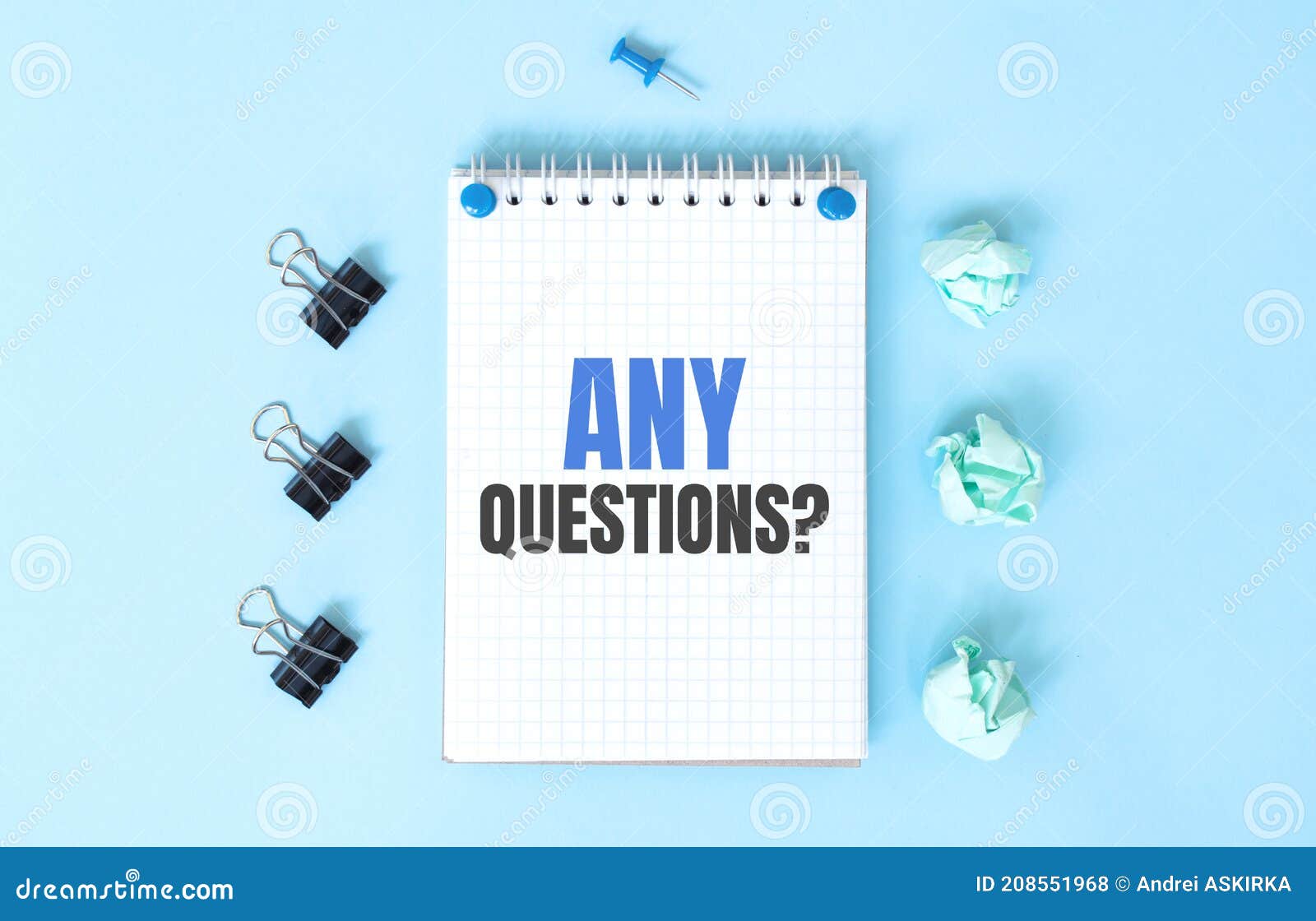 White Notepad with Text ANY QUESTIONS and Office Tools on the Blue ...