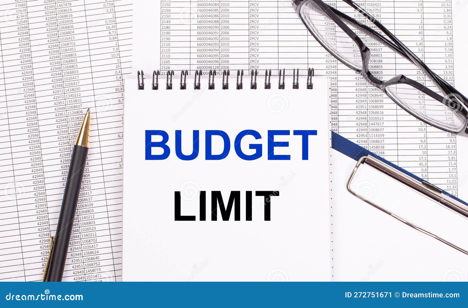 A White Notepad with the Text BUDGET LIMIT a Pen, Reports and Glasses ...