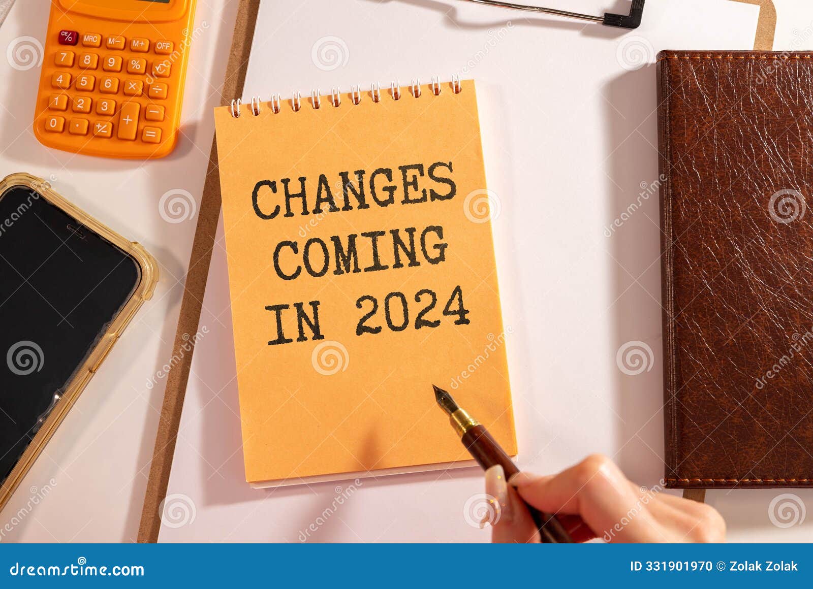 White Notepad with Text CHANGES COMING in 2024 and Office Tools on the ...