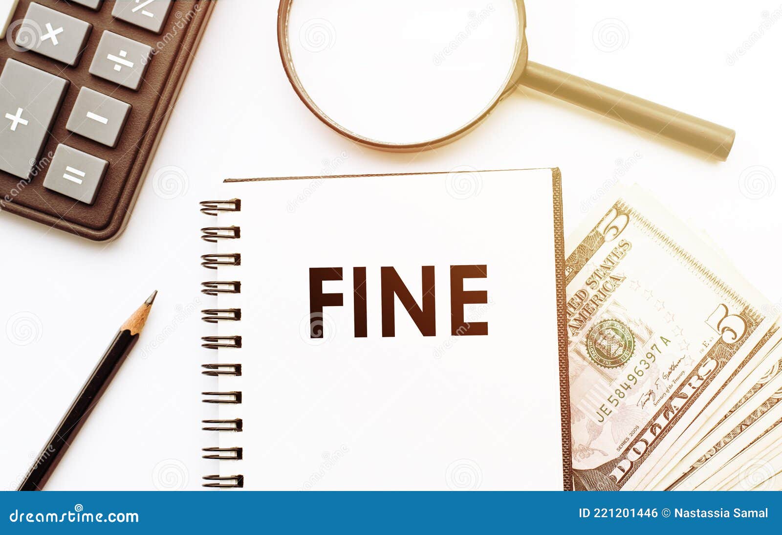 White Notepad with the Text of the FINE on the Background of Dollars ...
