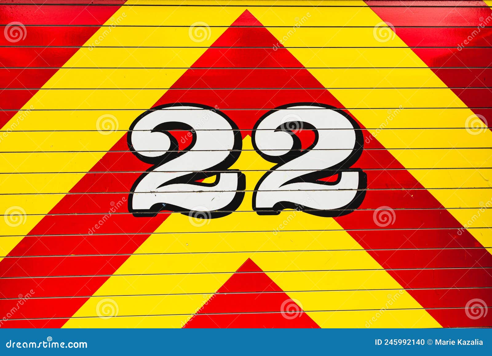 White Number 22 Outlined in Black on Bright Red and Yellow Chevron ...