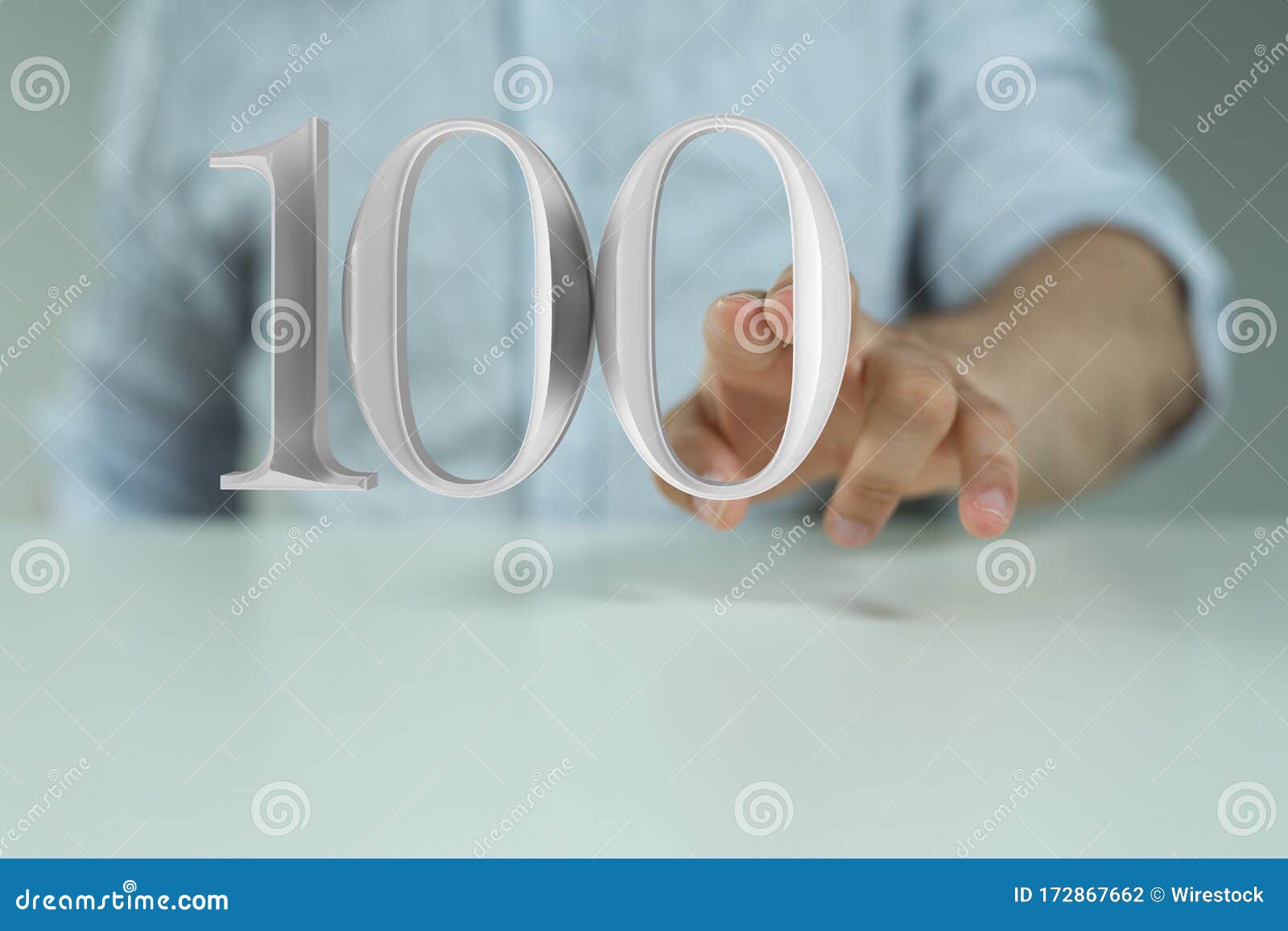White Number 100 on a Table Behind a Person S Fingers Stock Photo ...