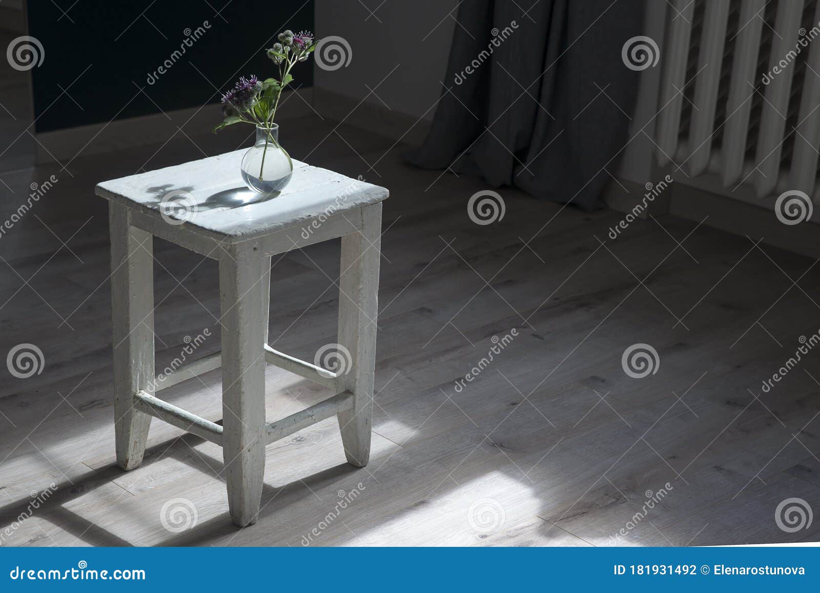 White Old Stool is in the Middle of the Room with a Vase with Flowers ...