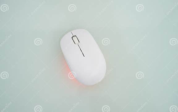 White Optical Mouse with Light on Glass Top Table Stock Photo - Image ...