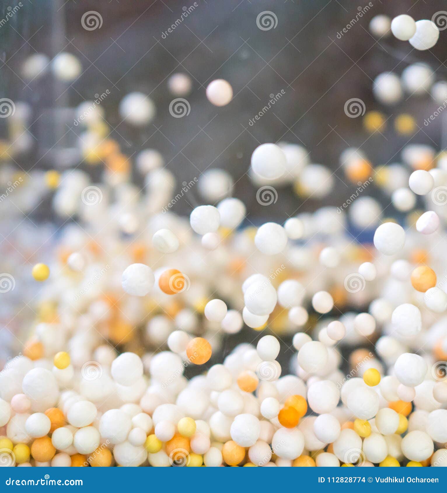 White and Orange Floating Foam Sphere in Acrylic Container Stock Photo ...