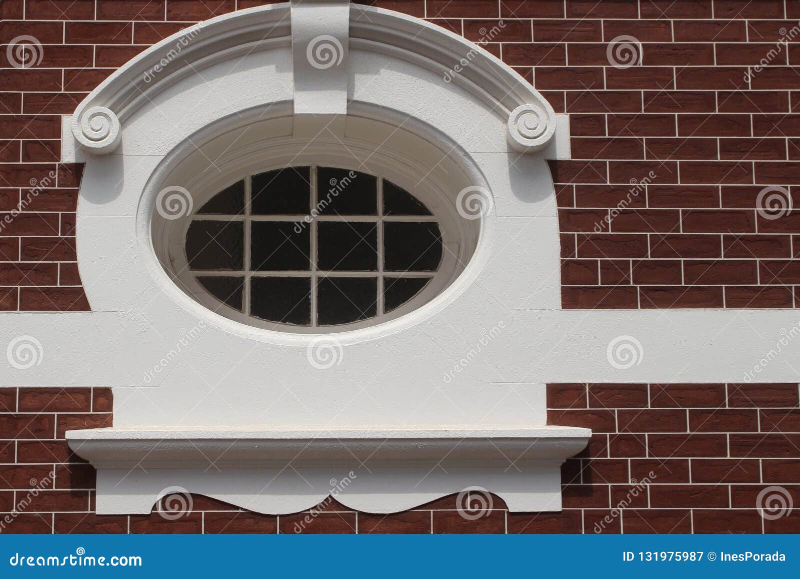 White Oval Window with Stucco in Ruby-colored Brick Wall Stock Image ...
