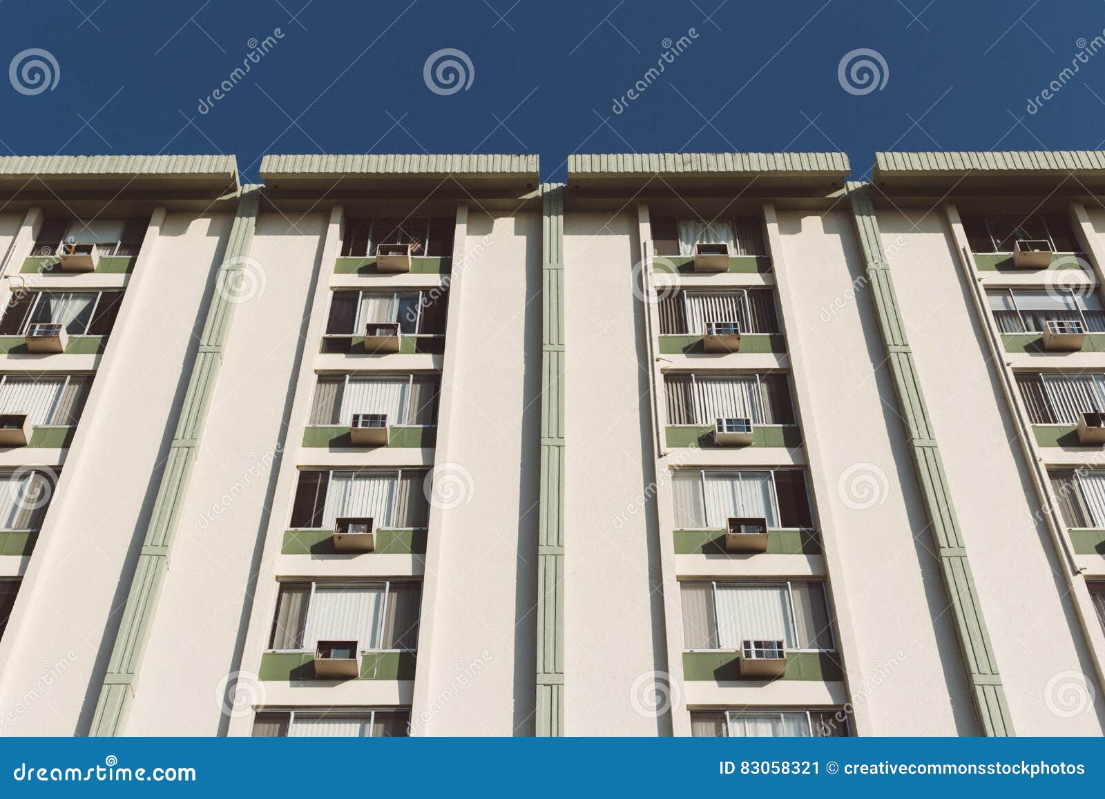 White Painted Residential Building Under Clear Skies Picture. Image ...