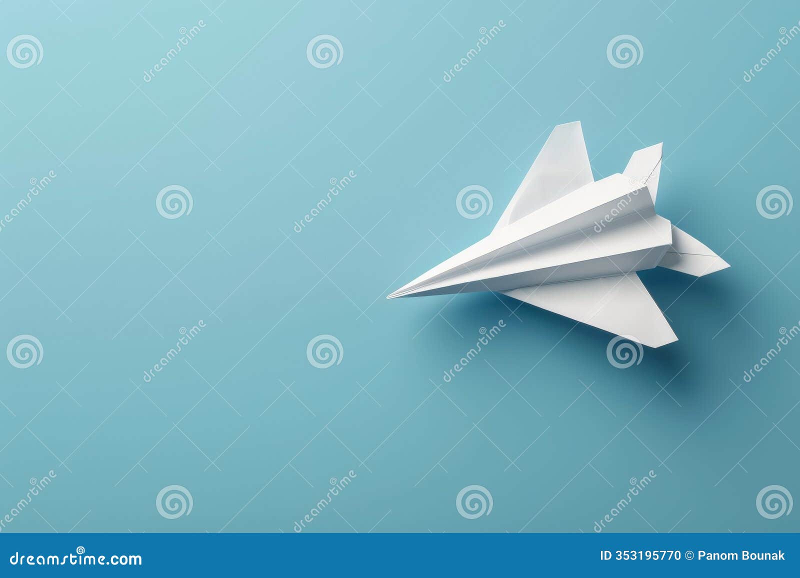 A White Paper Airplane on a Light Blue Background Creating a Minimalist ...