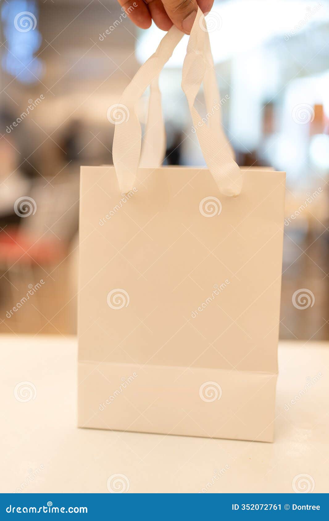 A White Paper Bag with Fabric Handles Stock Image - Image of package ...