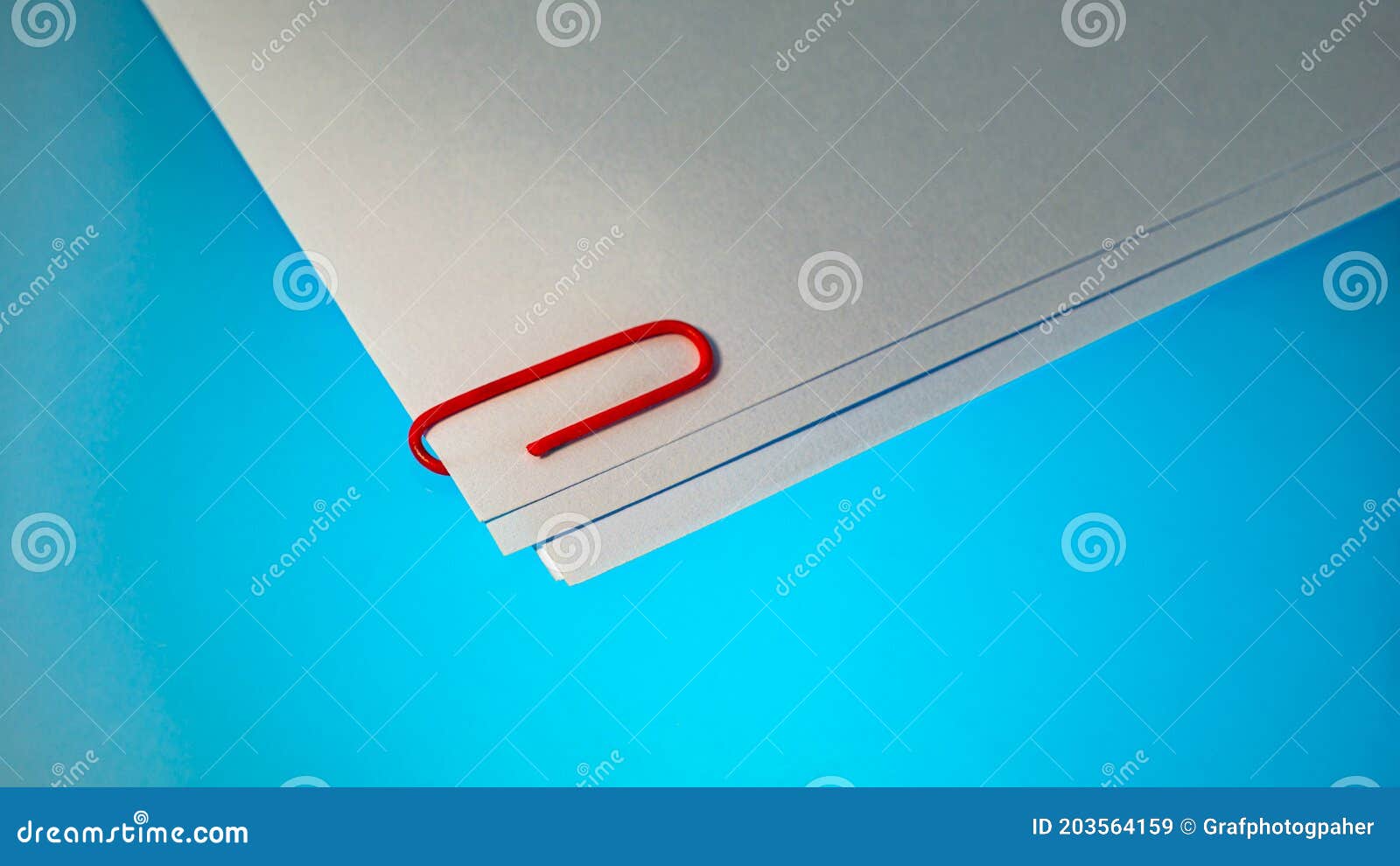 White Paper Connected with a Red Paper Clip on a Blue Background Stock ...