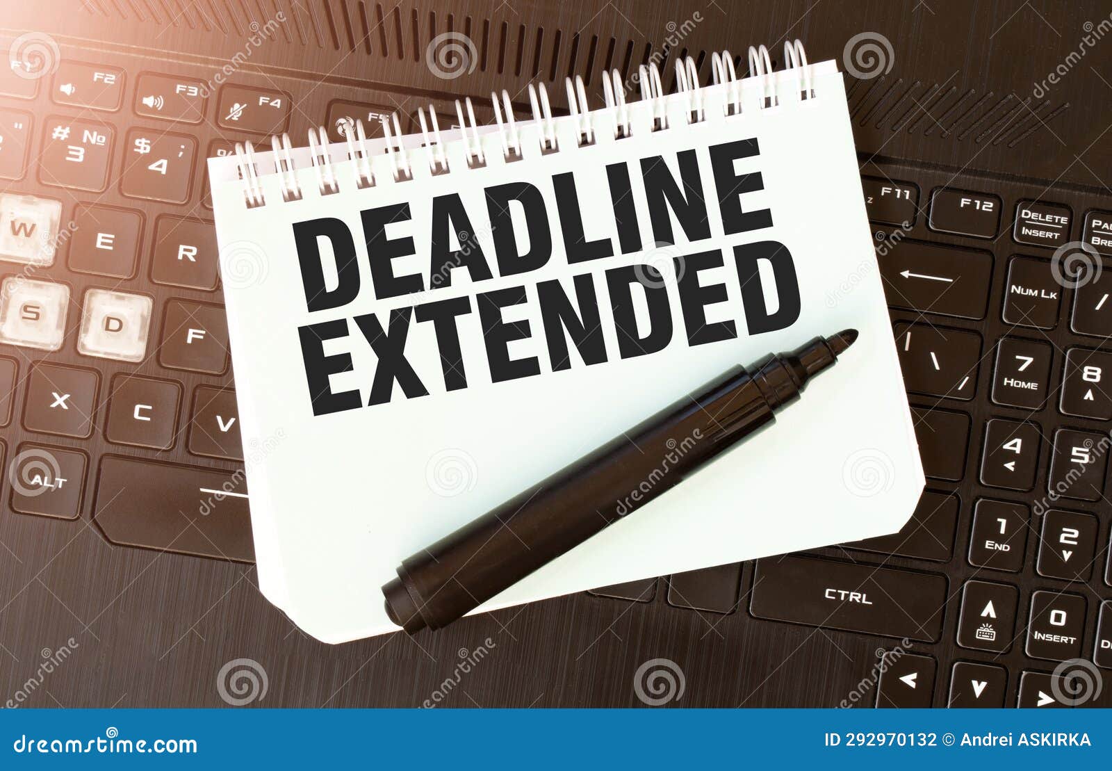White Paper Sheet with Text DEADLINE EXTENDED on the Black Laptop Stock ... White Paper Sheet with Text DEADLINE EXTENDED on the Black Laptop Stock ...