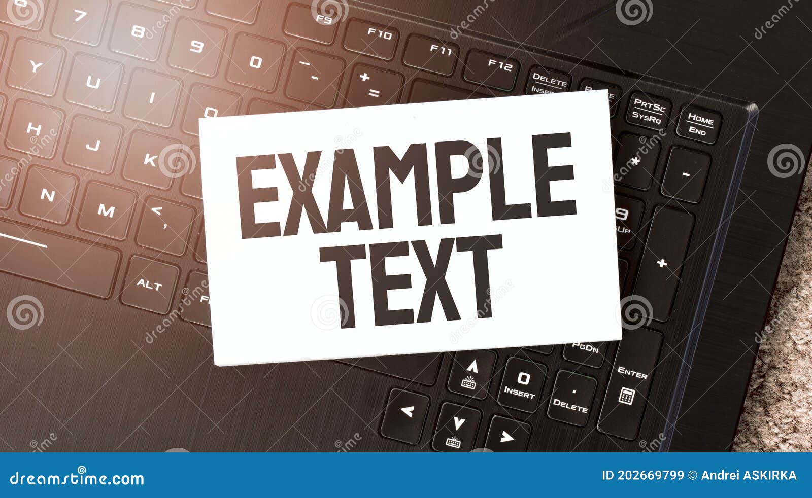 White Paper Sheet with Text EXAMPLE TEXT on the Black Laptop Stock ...