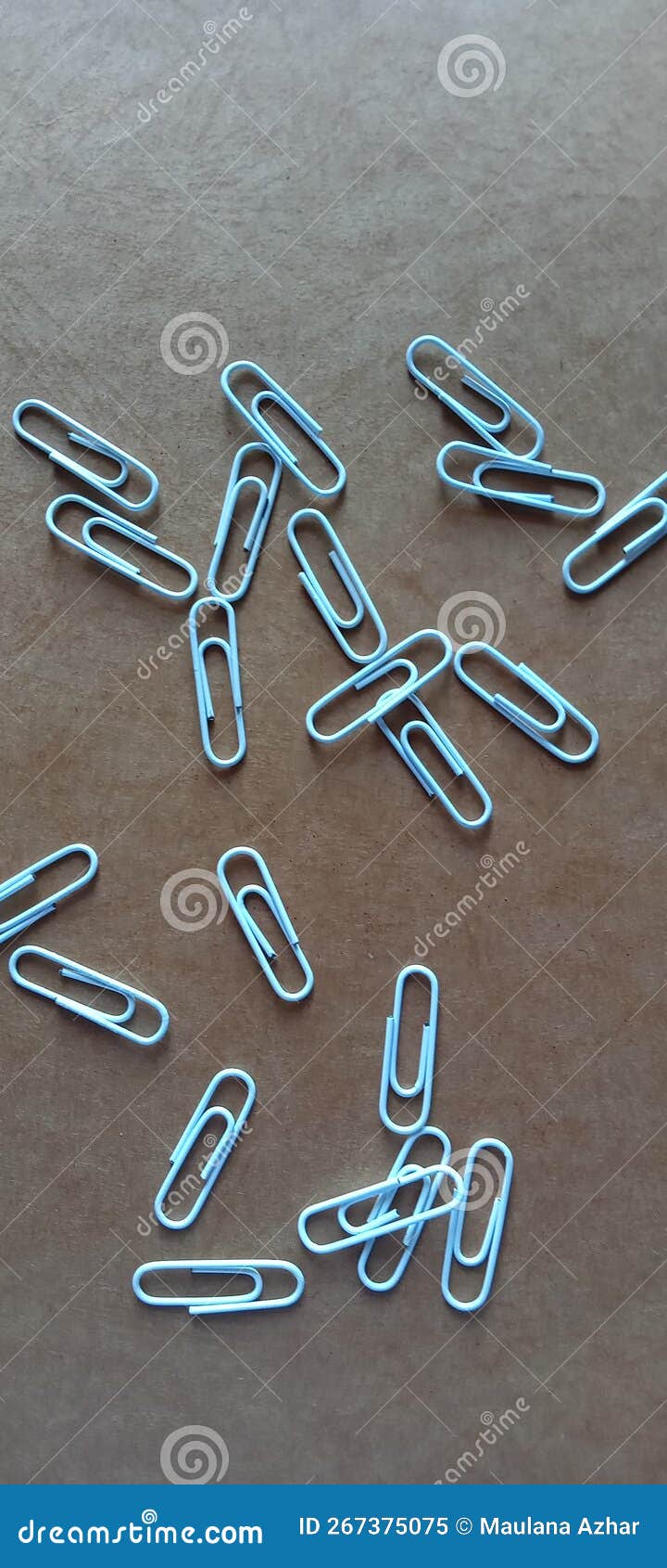 White Paperclip in Brown stock image. Image of line - 267375075