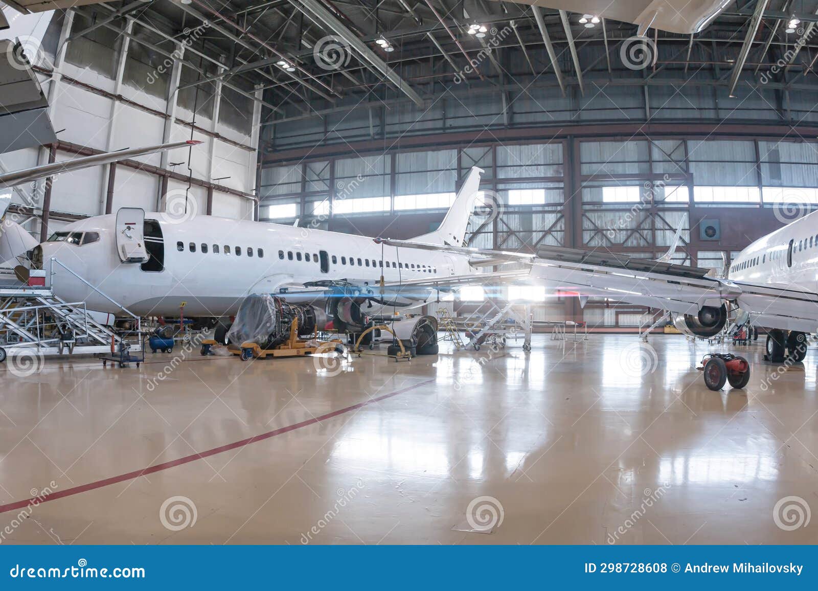 White Passenger Airplanes in the Aviation Hangar. Airliners Under ...