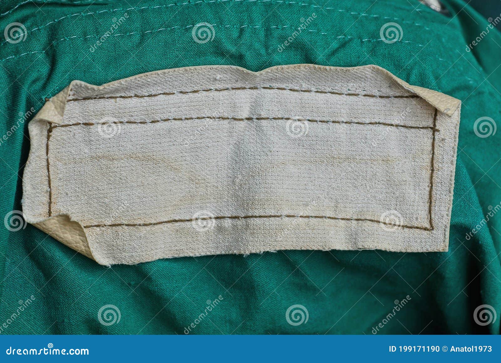 White Patch Made of Fabric on Green Cloth Stock Photo - Image of ...