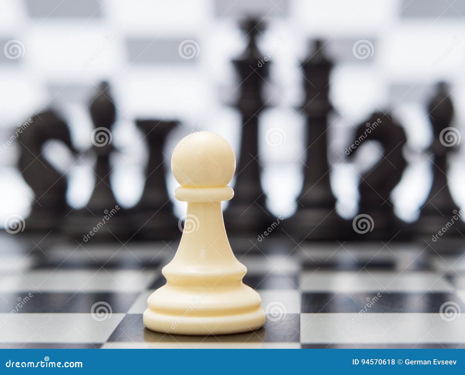 White Pawn Against the Background of Dark Chess Pieces Stock Photo ...