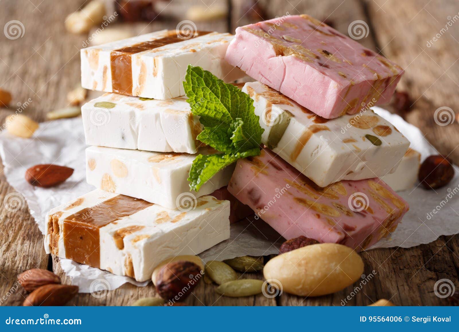 White, Pink and Brown Nougat with Nuts and Mint Closeup. Horizon Stock ...