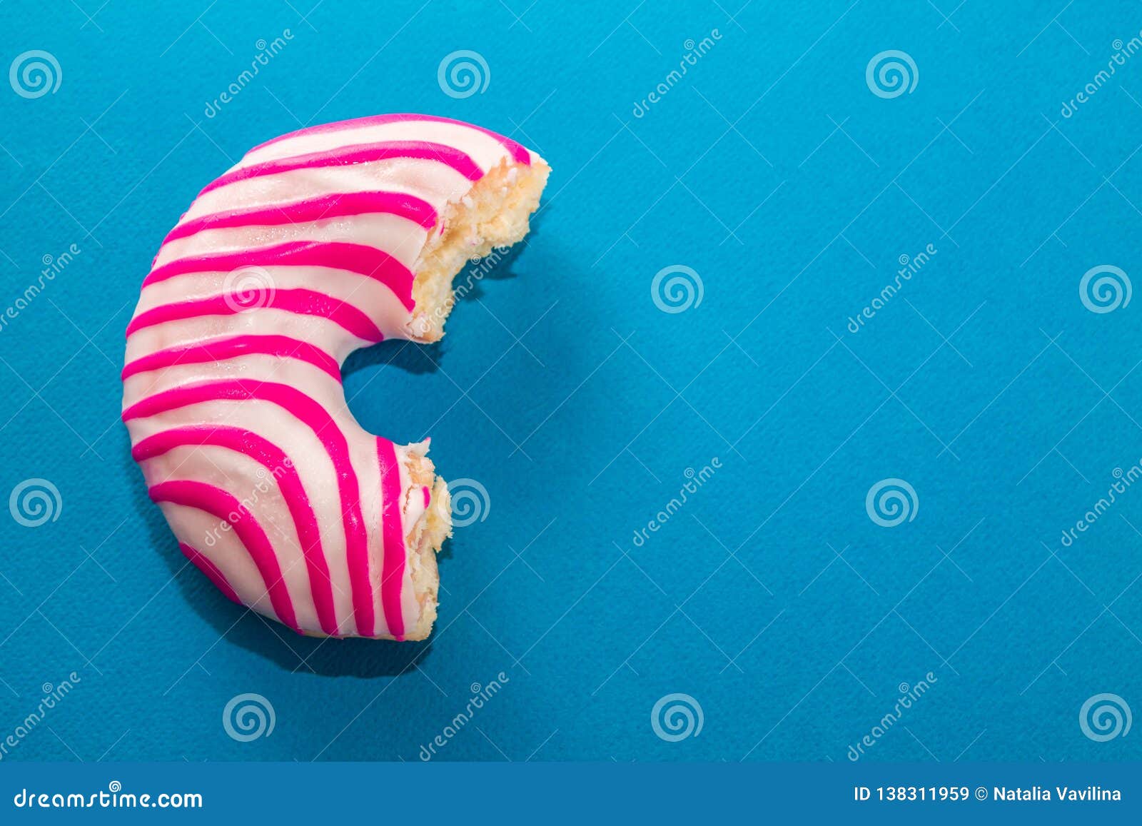 White Pink Half-bitten Donut Close-up on Bright Blue Background Stock ...