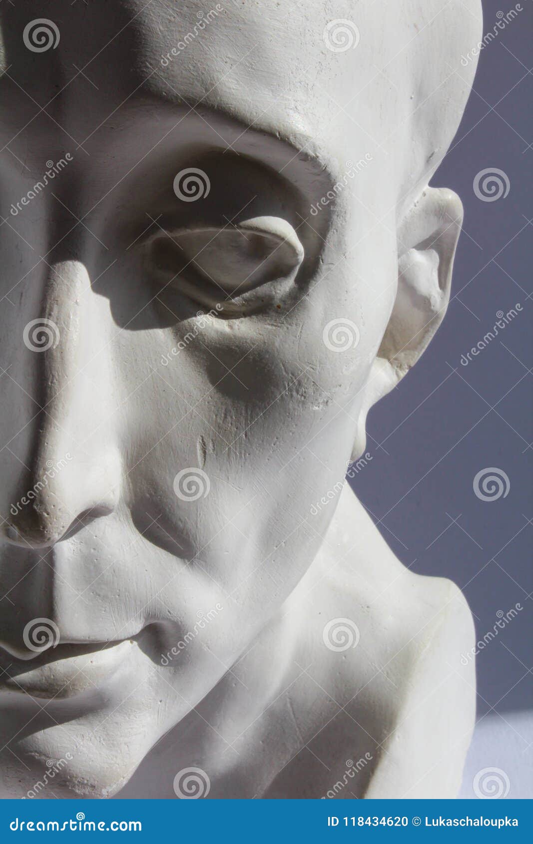 White Plaster Statue of Half Mans Head on Blue Grey Background Stock ...