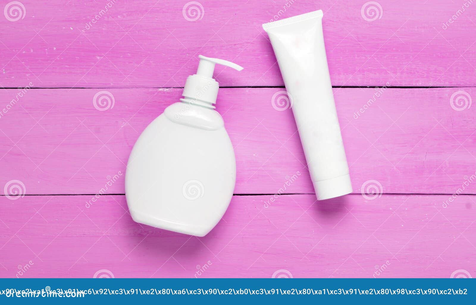 White Plastic Bottles of Cream on Violet Wooden Table, Top View Stock ...