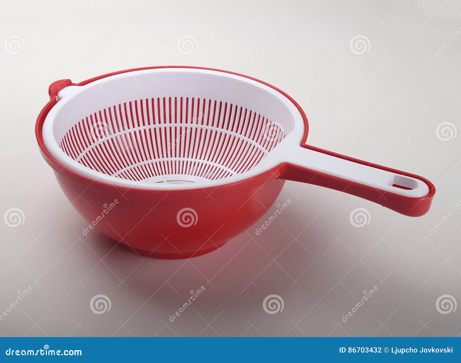 White Plastic Colander in Red Bowl Stock Photo - Image of object ...
