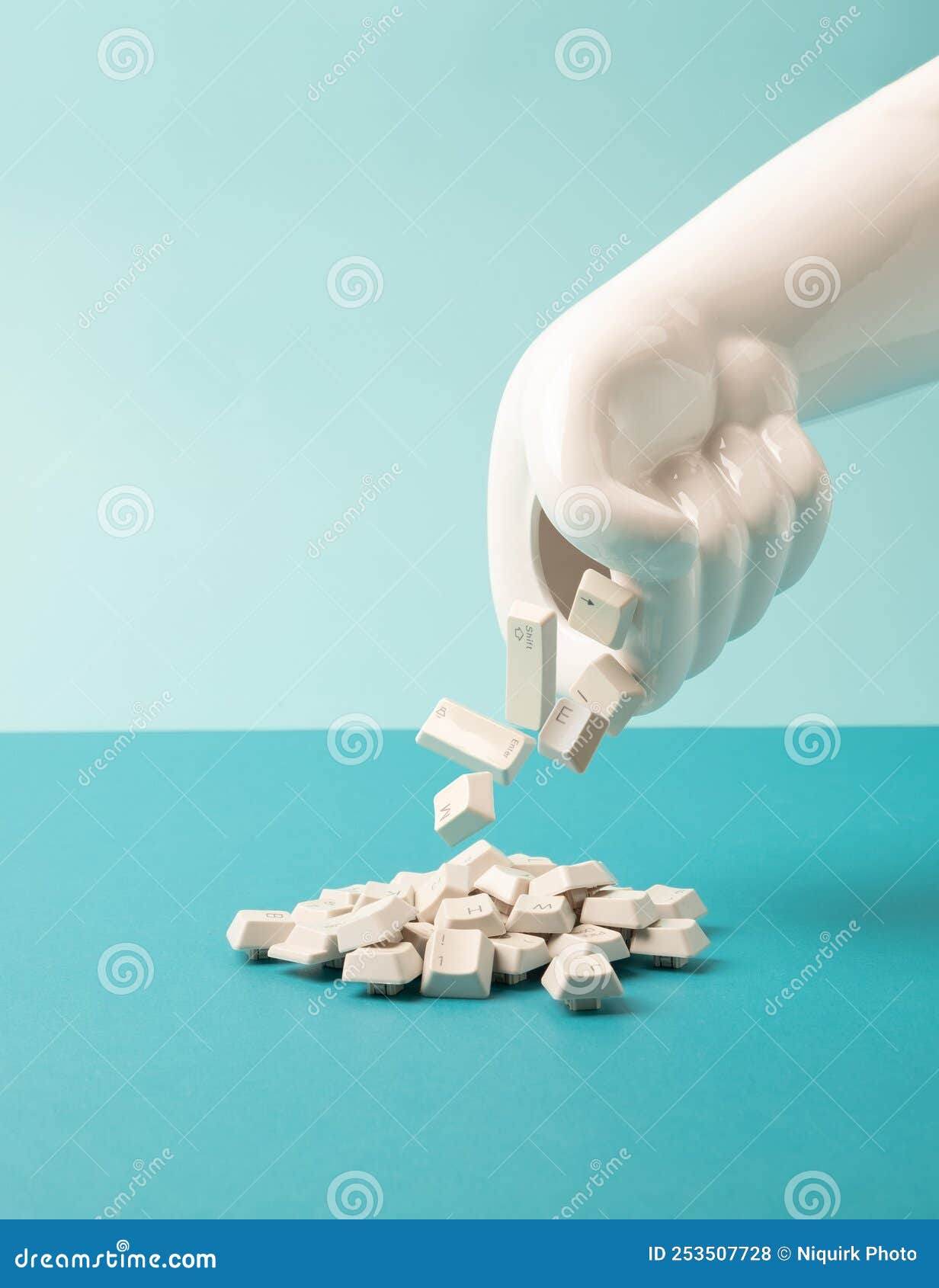 White Plastic Hand Throwing Keyboard Keys on a Pastel Blue Background ...