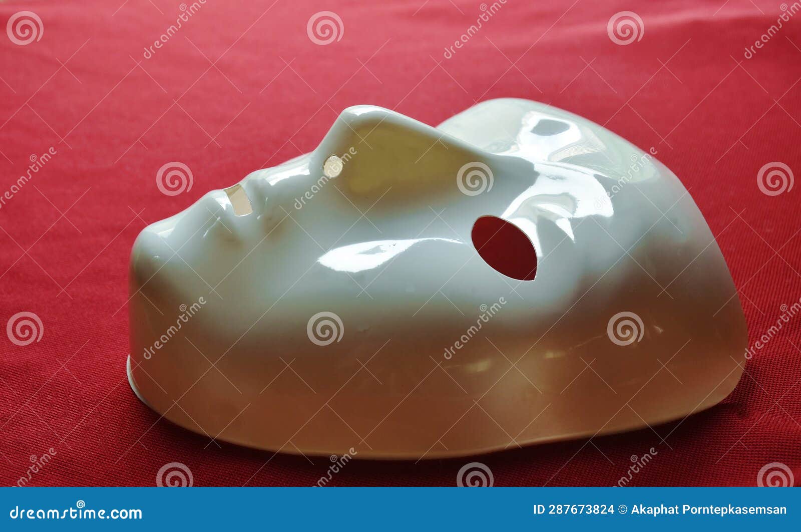 White Plastic Human Face Mask on Red Fabric Background Stock Photo ...