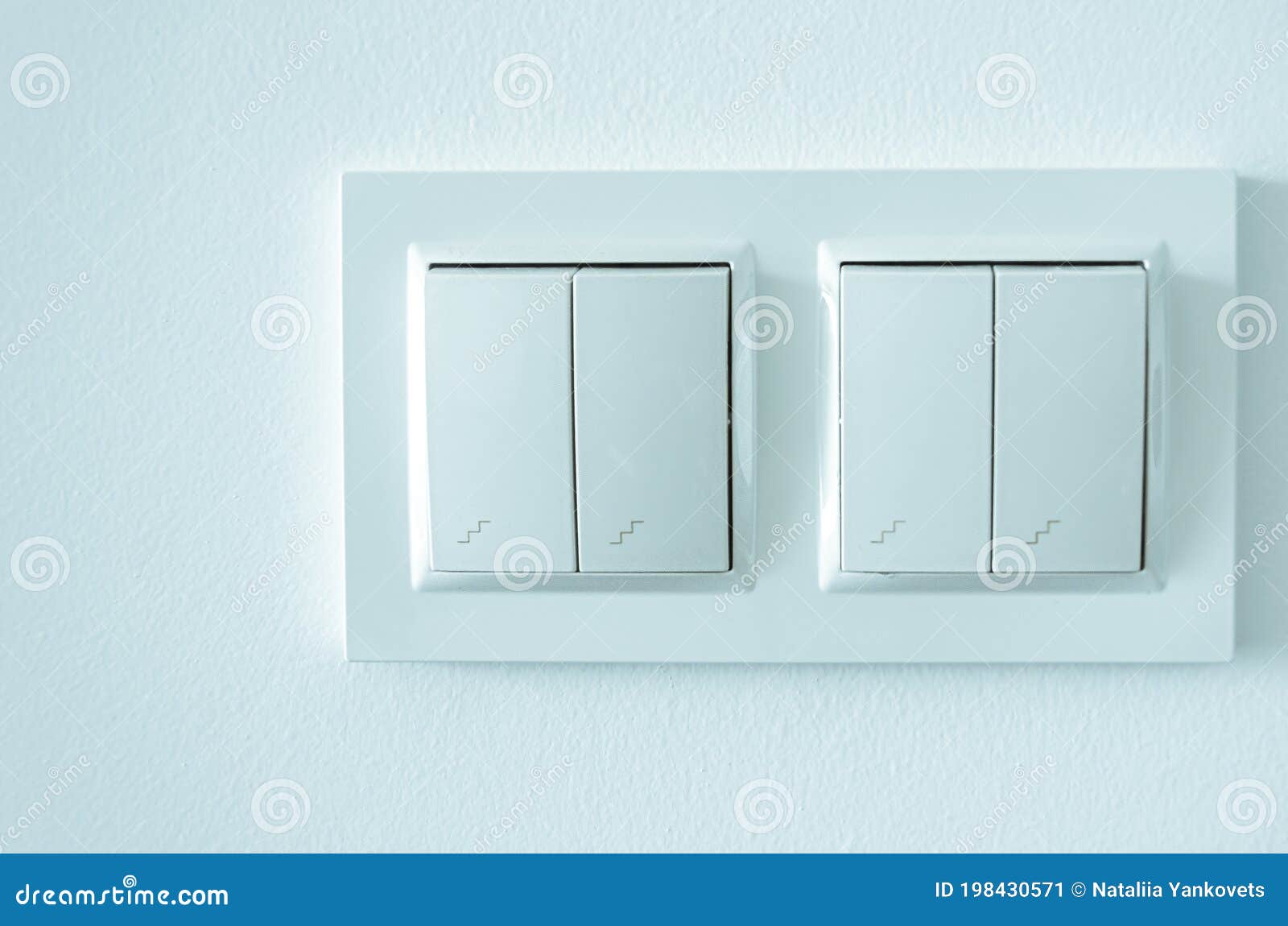 White Plastic Pass-through Electricity Switches on a White Wall Stock ...