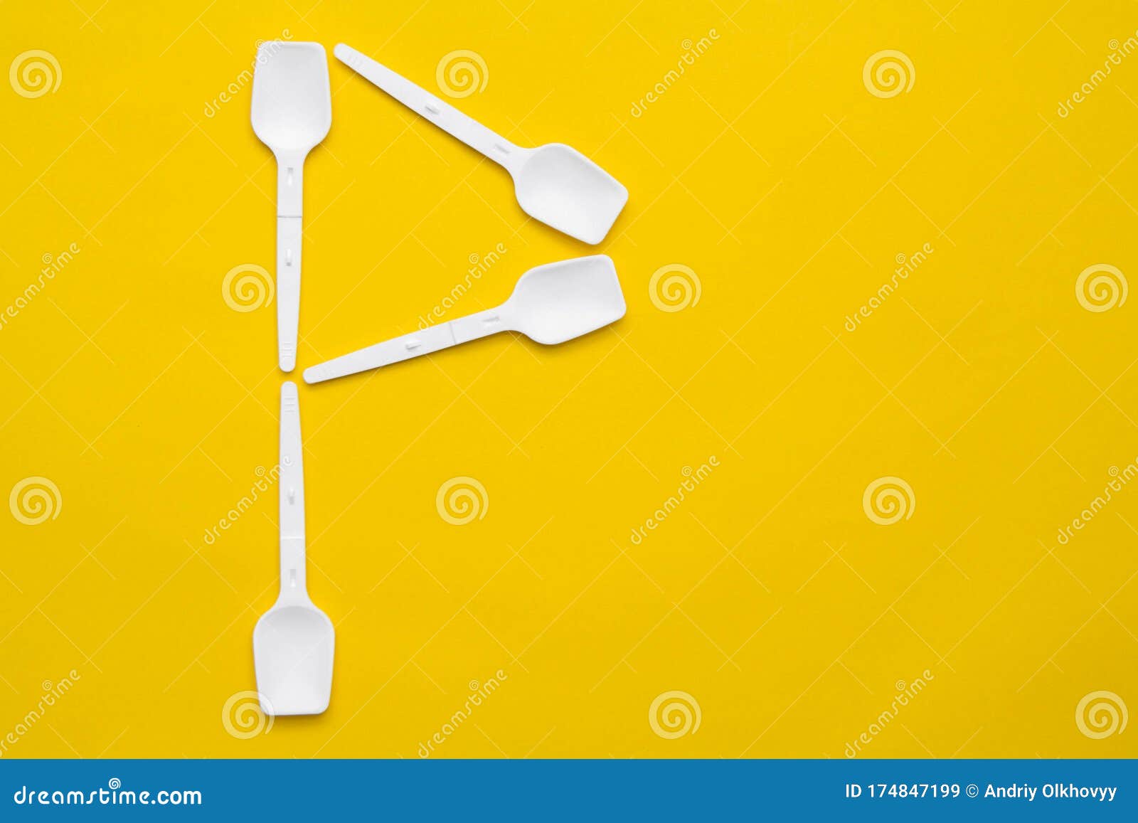 White Plastic Spoons in the Form of Letter P on Yellow Background. Top ...