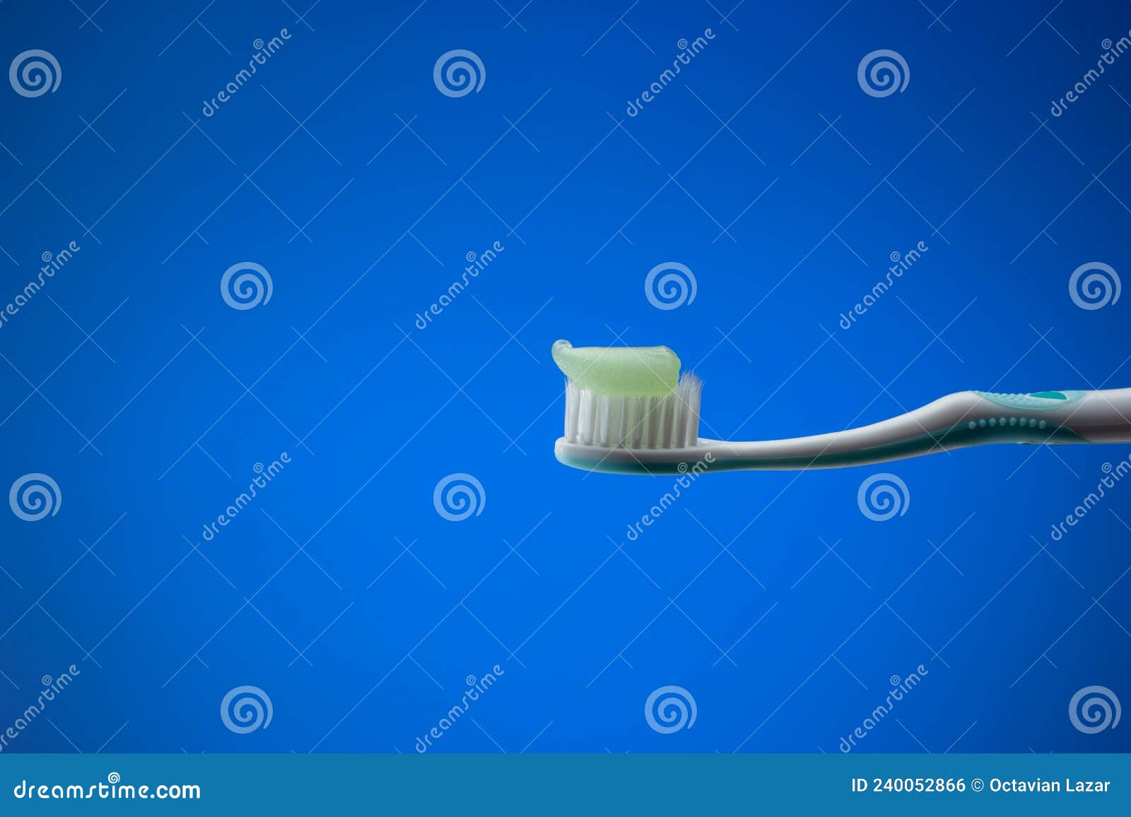 White Plastic Toothbrush with Light Blue Toothpaste. Close Up Studio ...