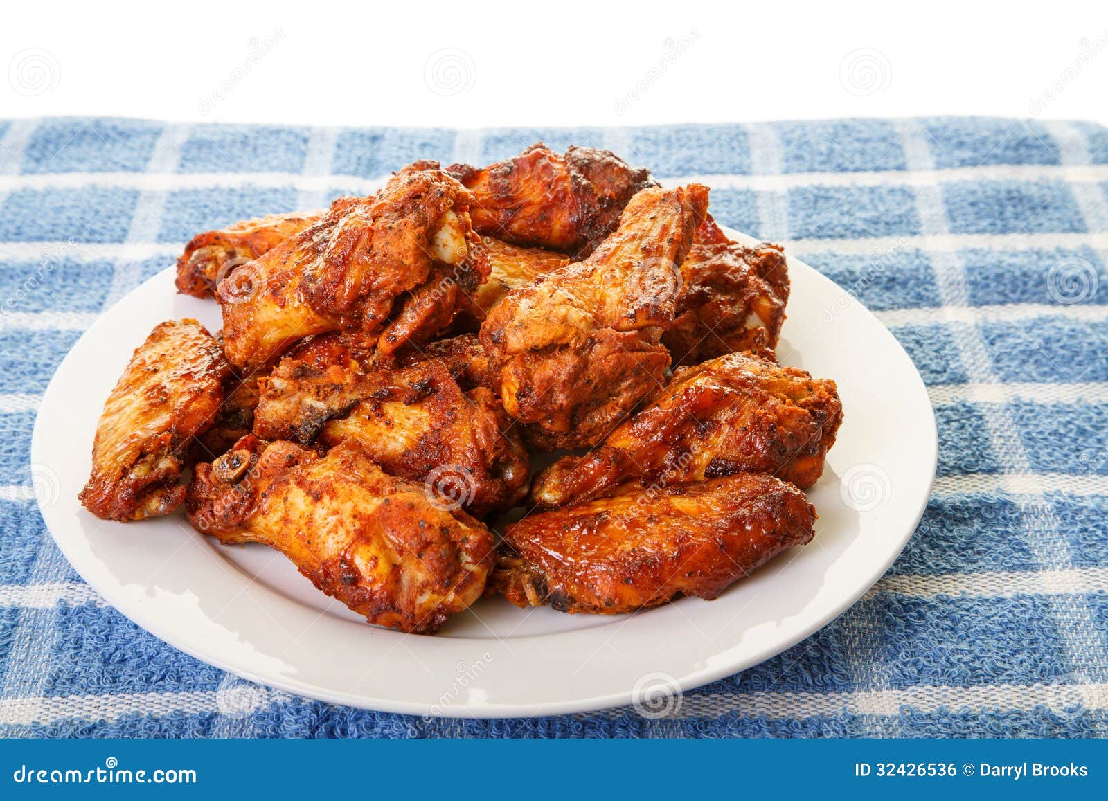 White Plate of Chicken Wings on Blue Mat Stock Photo - Image of backed ...