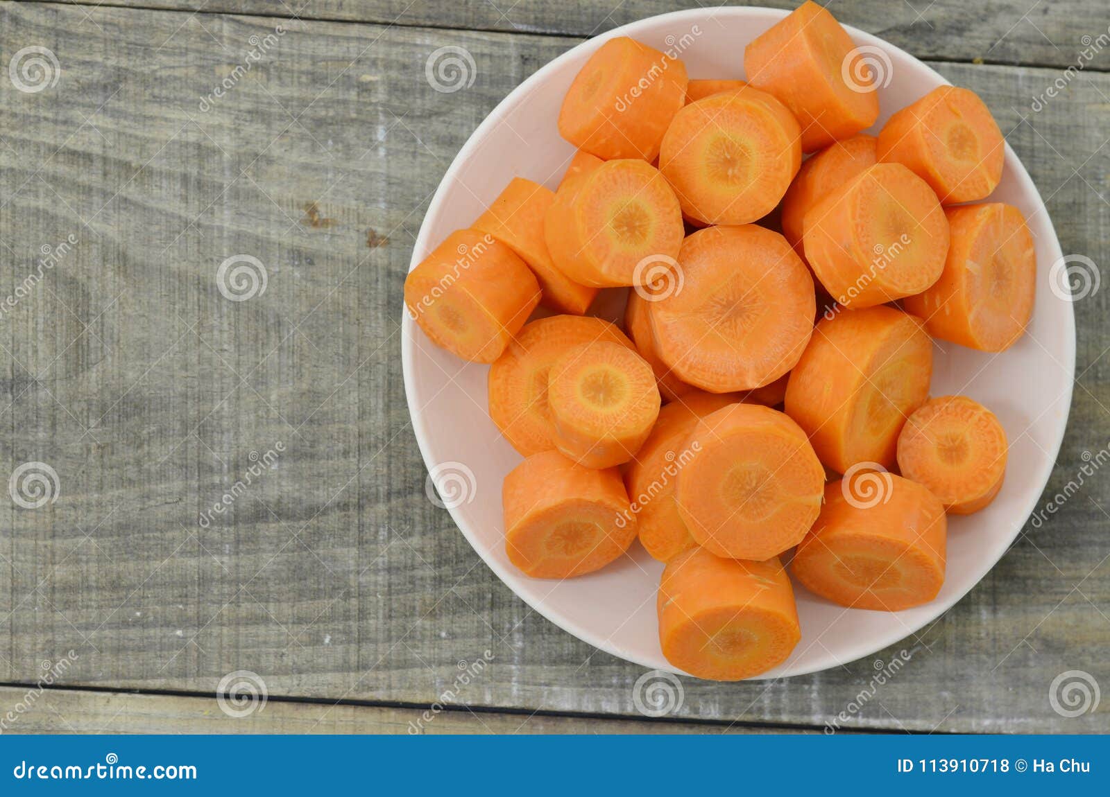 White Plate with Cut Carrots Thick on Wooden Background Stock Photo ...