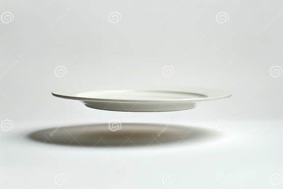 A White Plate Flying through the Air Stock Photo - Image of messy ...