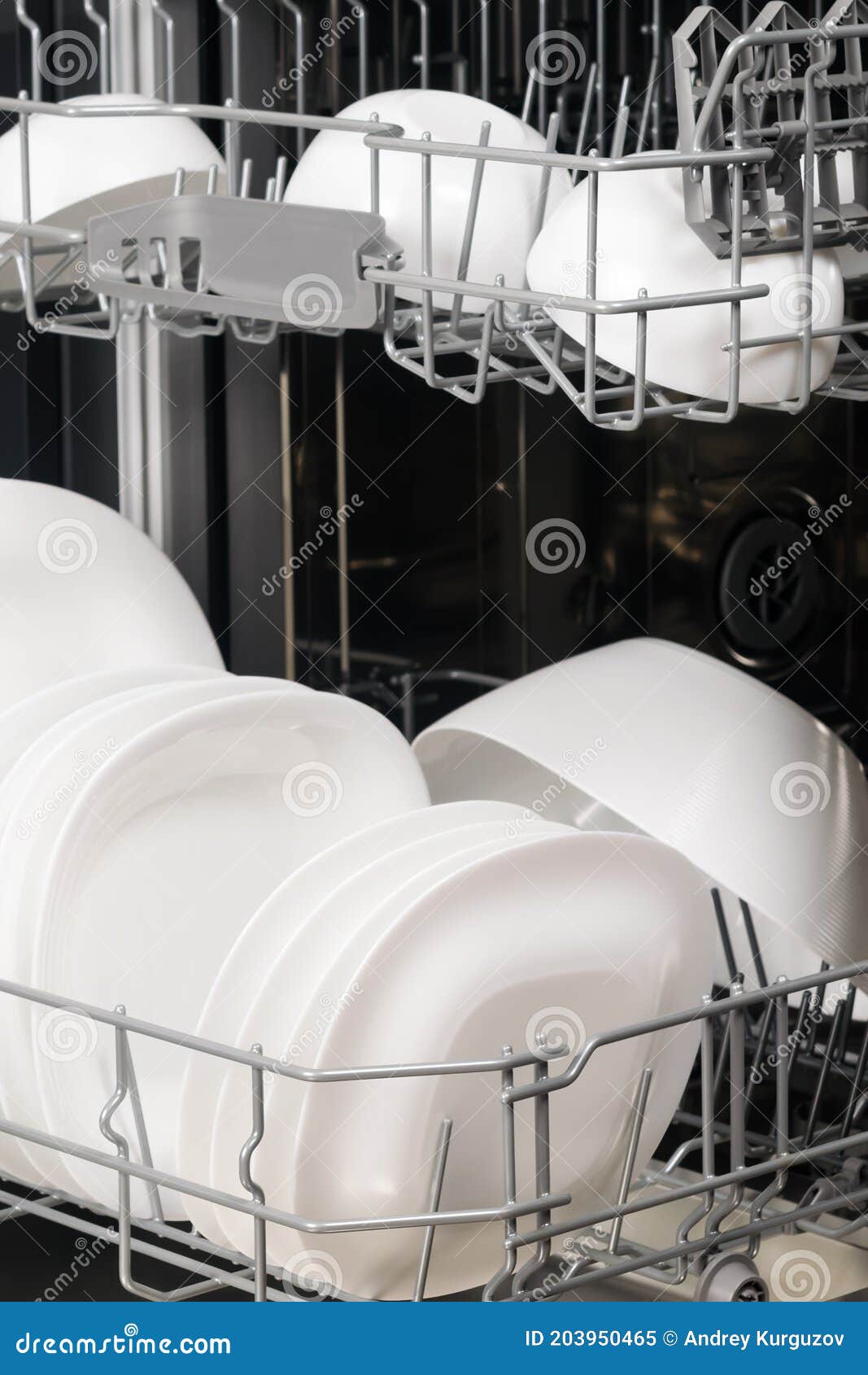 White Plates and Cups in the Dishwasher Compartment, Close-up, Side ...