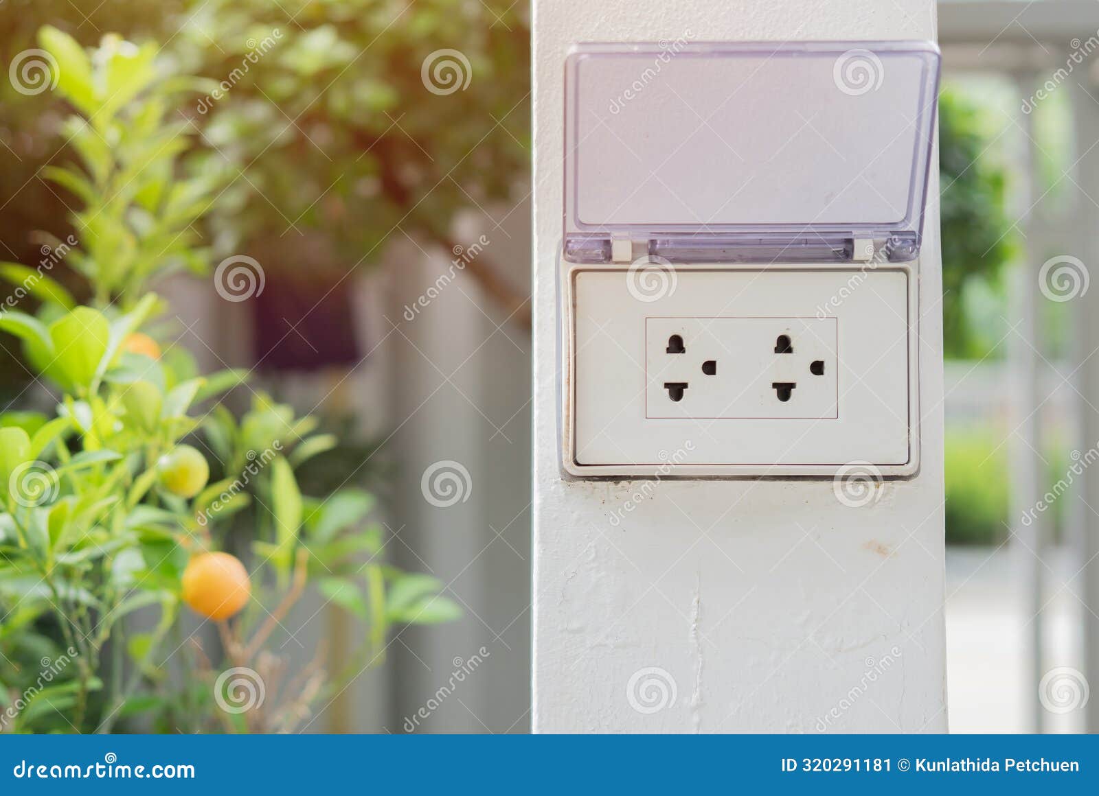 White Plug on White Wall with a Garden in the Background, Plug Socket ...