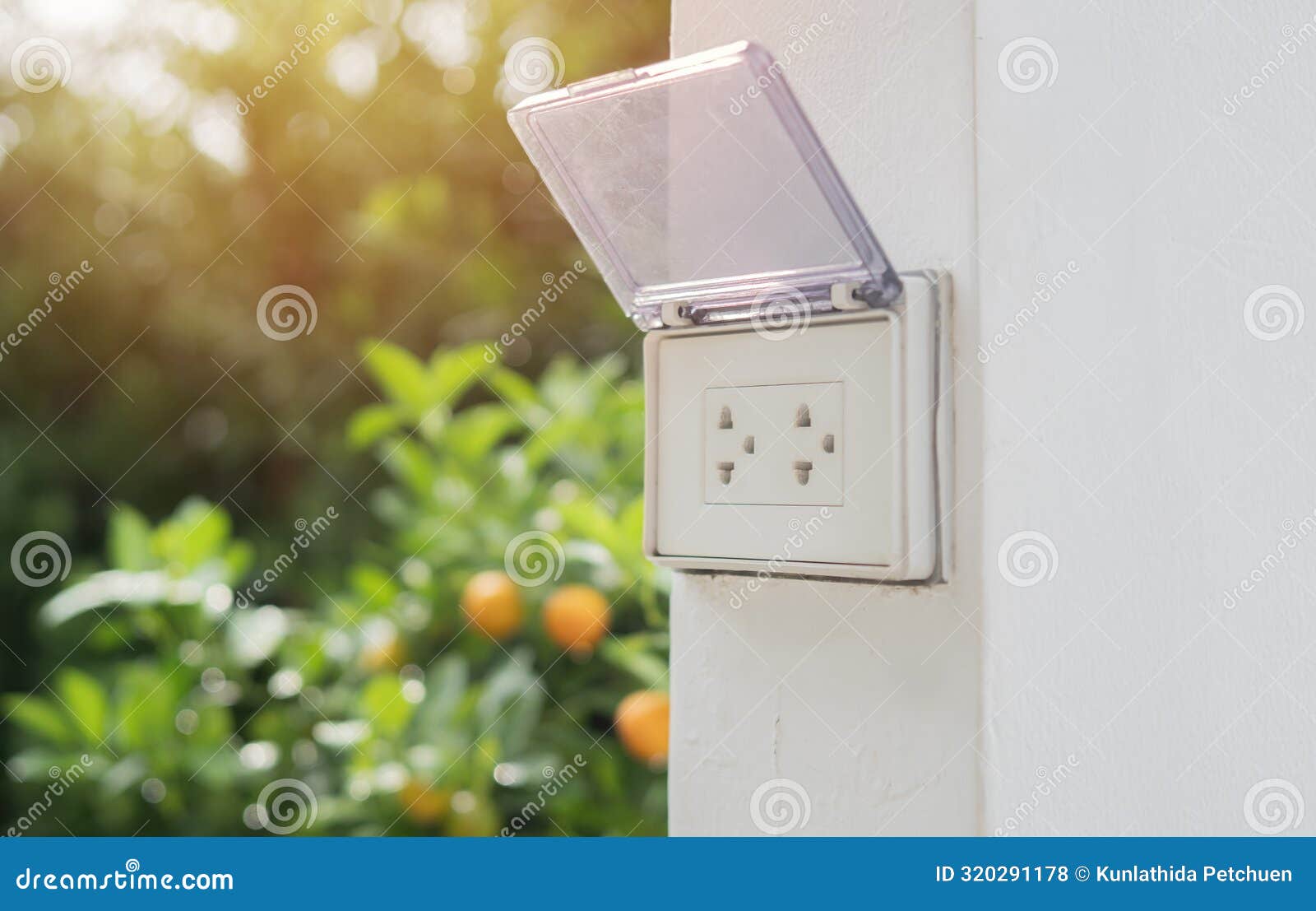 White Plug on White Wall with a Garden in the Background, Plug Socket ...