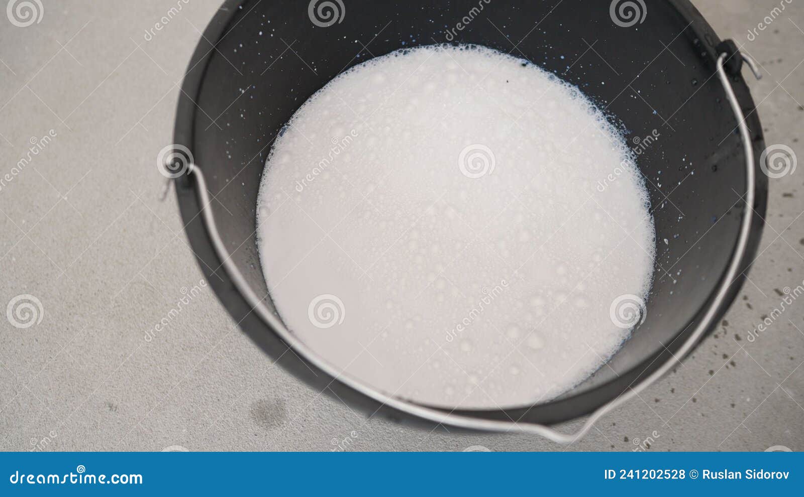 White Primer Mortar in a Bucket. Bucket with White Paint. Black Bucket ...