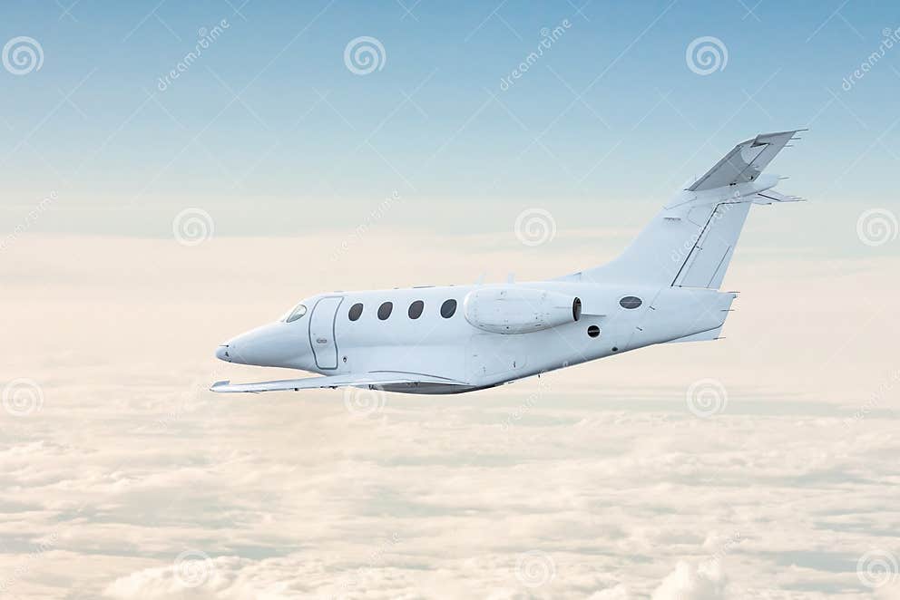 White Private Jet Fly in the Air Above the Clouds Stock Image - Image ...