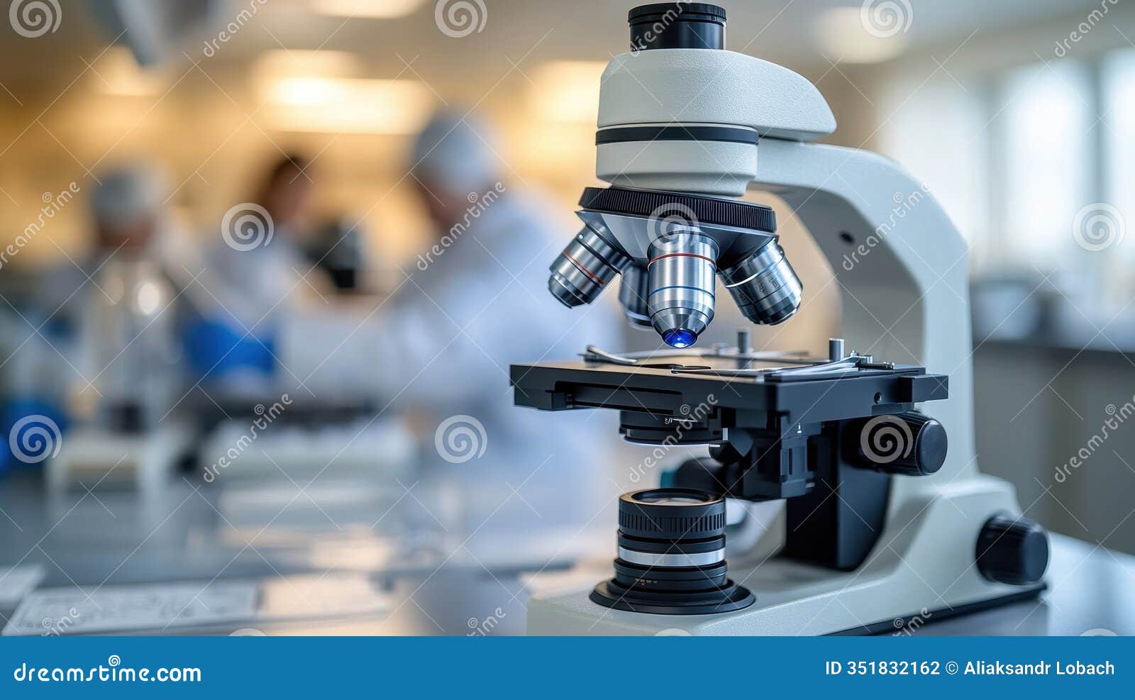 A White Professional Microscope Stands on a Table in a Scientific ...
