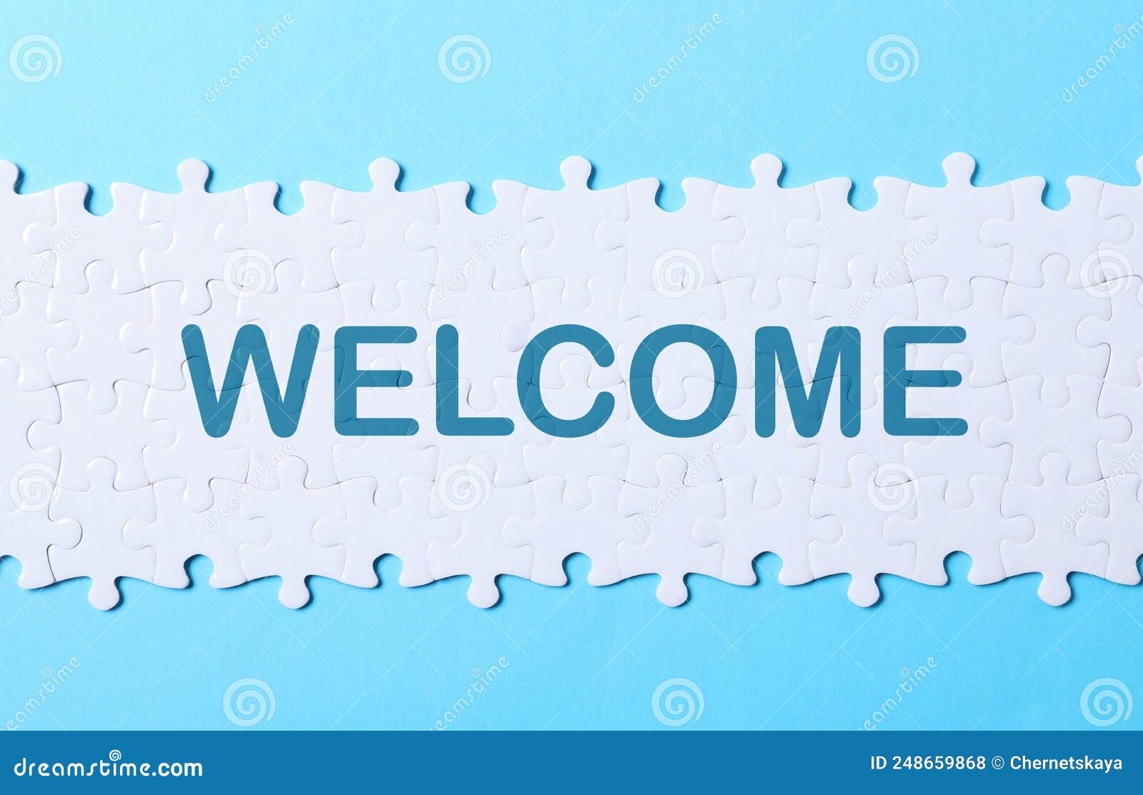 White Puzzle Pieces and Word WELCOME on Light Blue Background, Top View ...