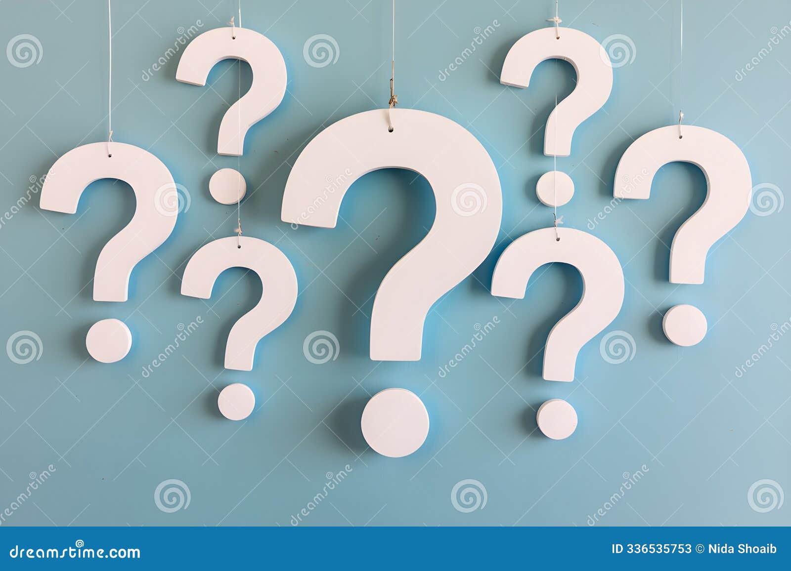 White Question Marks Hang Against Light Blue Background, Creating ...